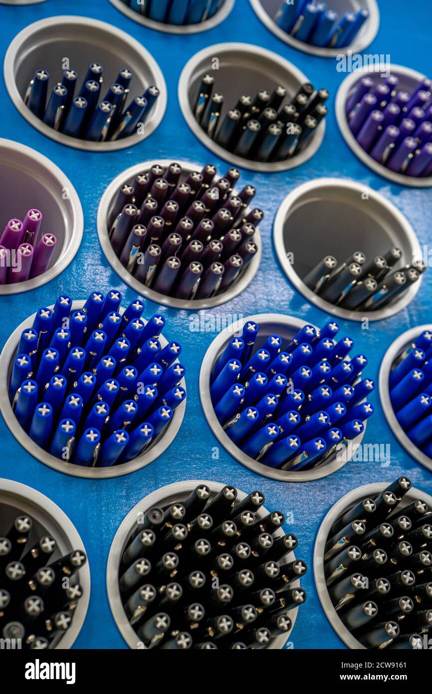 Colorful pens arranged on round shelves selling stationery ...
