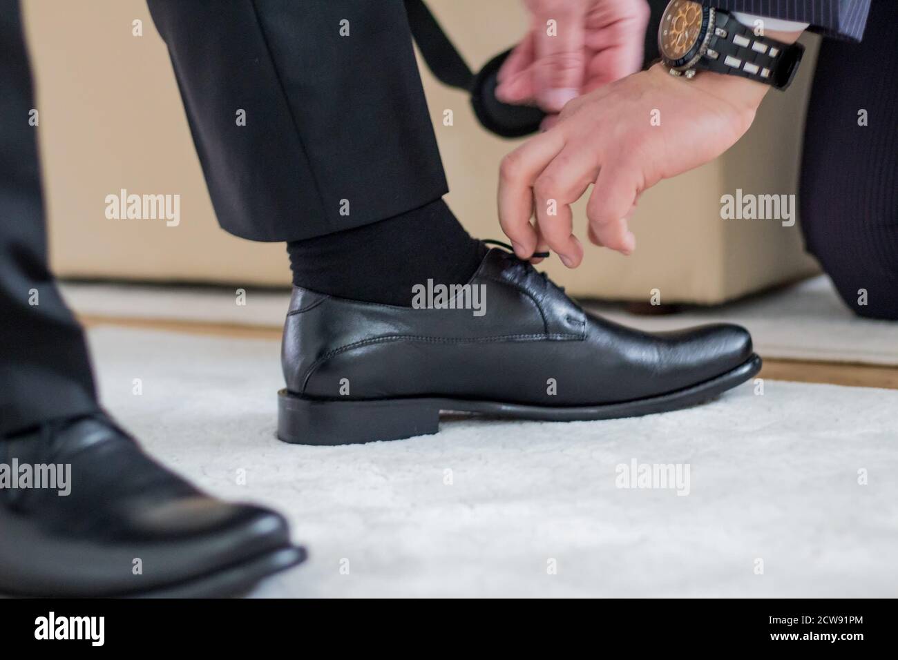 Groom putting on his shoes for the wedding ceremony Stock Photo - Alamy