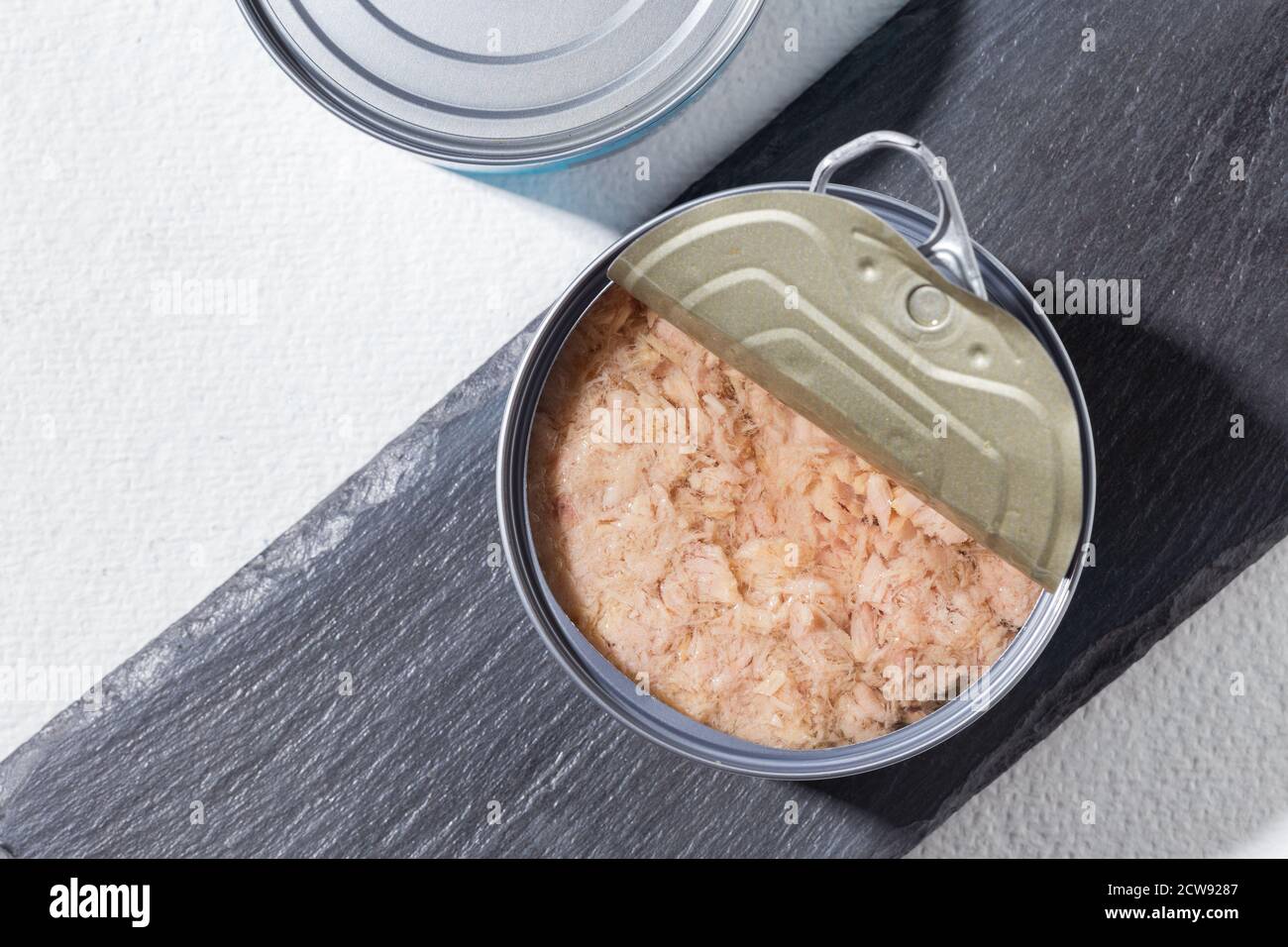 Open can of tuna on white background, close-up image Stock Photo - Alamy