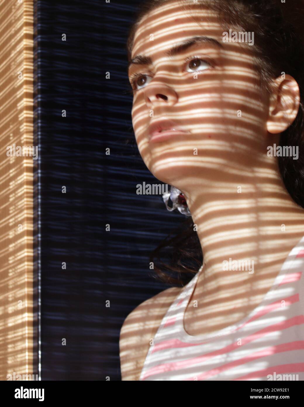 Close-up of a young girl's face looking out the window Stock Photo - Alamy