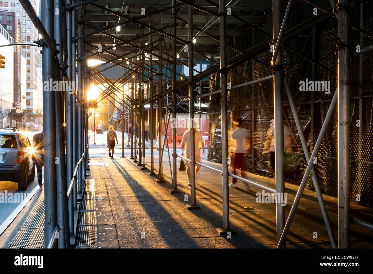 People walking under construction scaffolding on the streets of New ...
