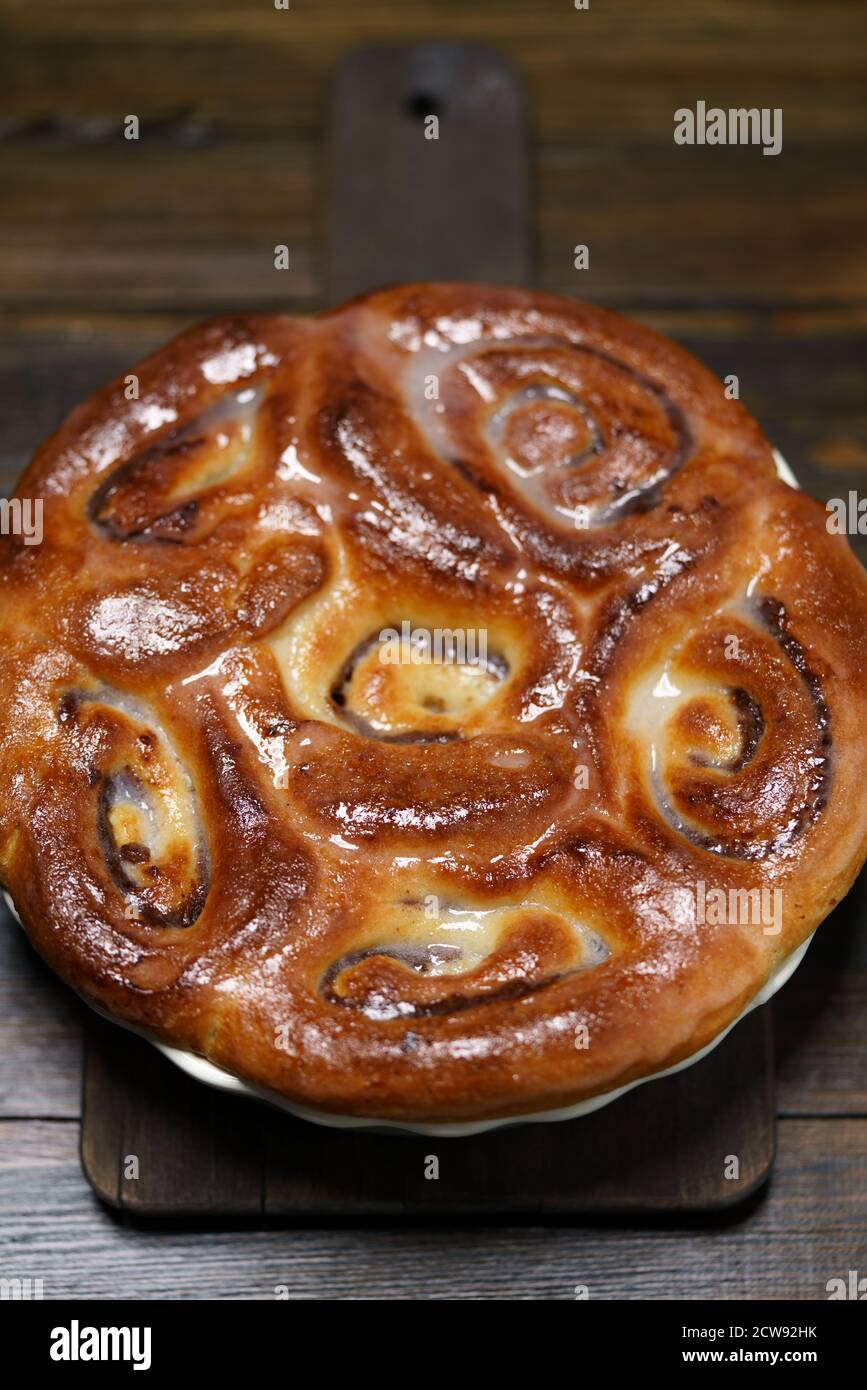 Date cinnamon buns in light blue ceramic dish. Dark wooden table, high ...