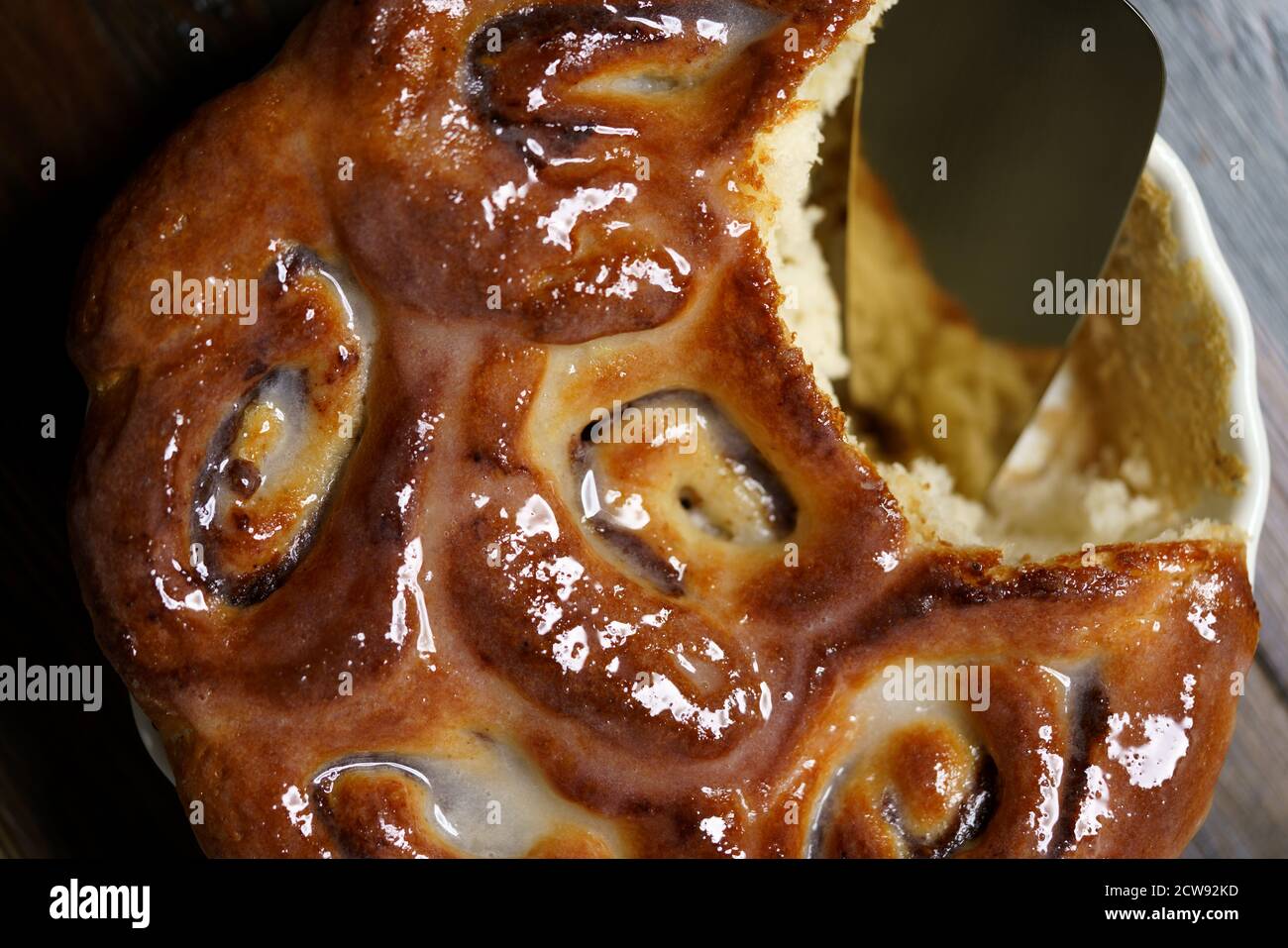 Date cinnamon buns in light blue ceramic dish. Dark wooden table, high ...
