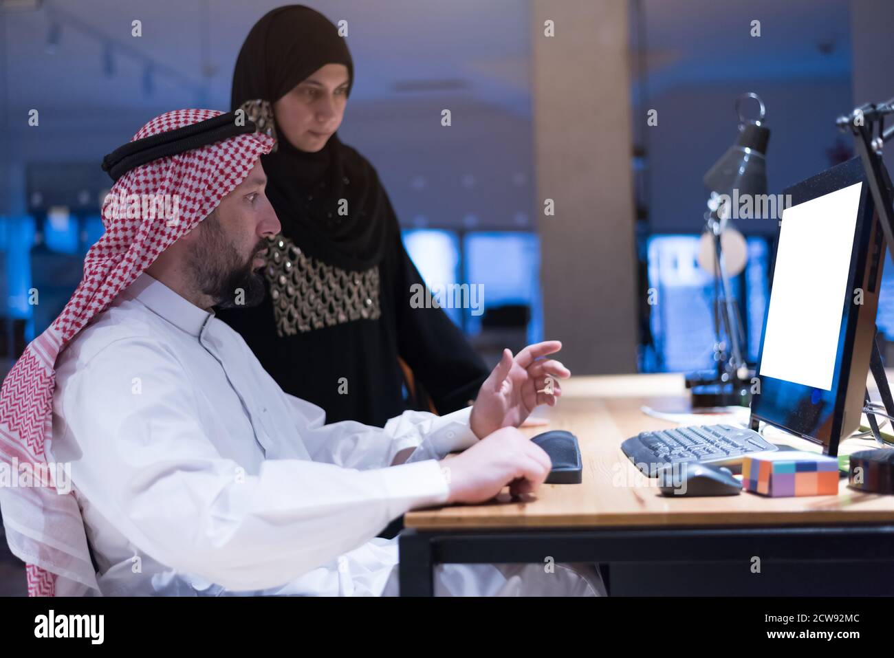 Handicapped Arabic businessman in tradition suit with female arabic ...