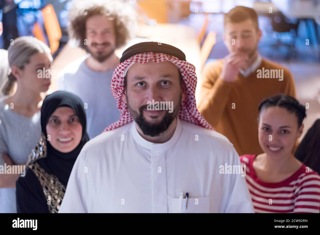 Portrait of young pretty successful multi-ethnic corporate close-knit ...