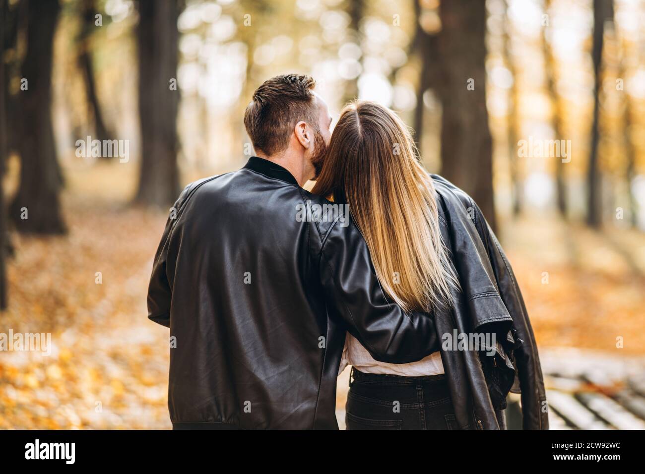 Portrait of a happy couple in love walking outdoor in the autumn park ...