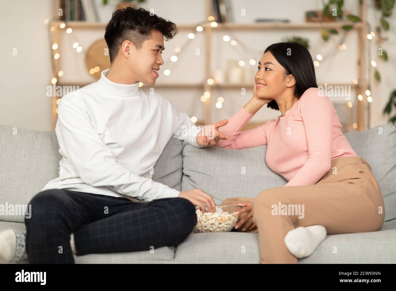 Japanese Couple Talking Enjoying Conversation Eating Popcorn Sitting At ...