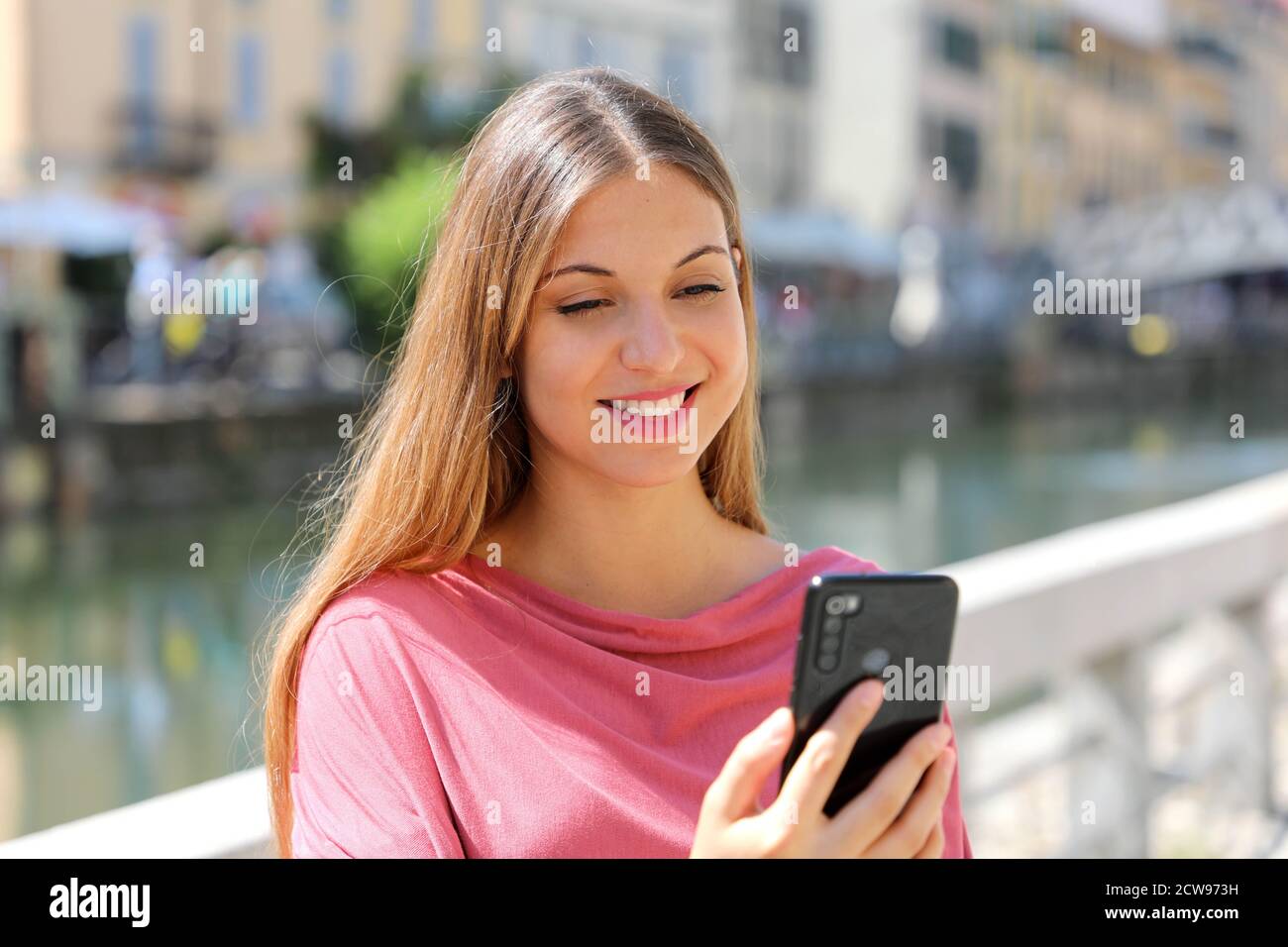 Close up of smiling young woman video calling with smartphone app in ...