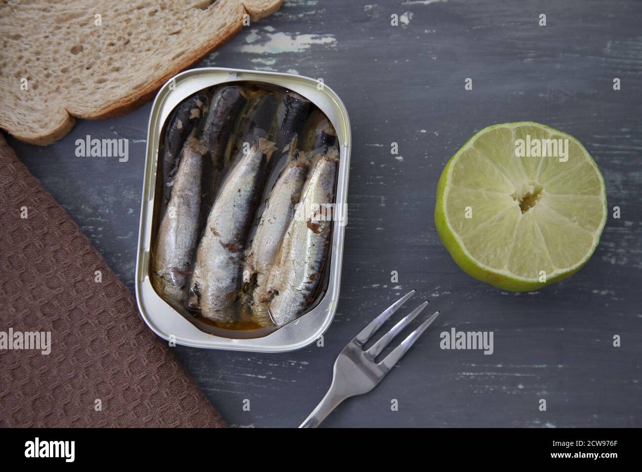 Closeup shot of tuna fish in a plastic can on the table set Stock Photo ...