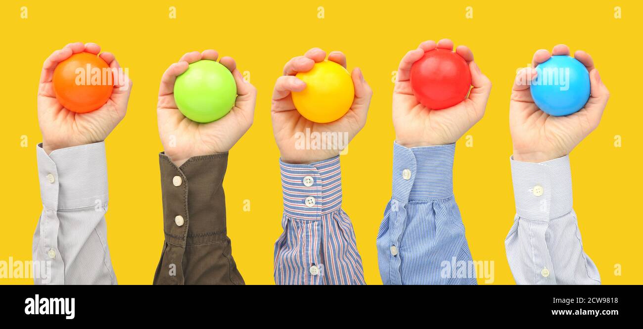 Men's hands with colorful plastic balls Stock Photo - Alamy