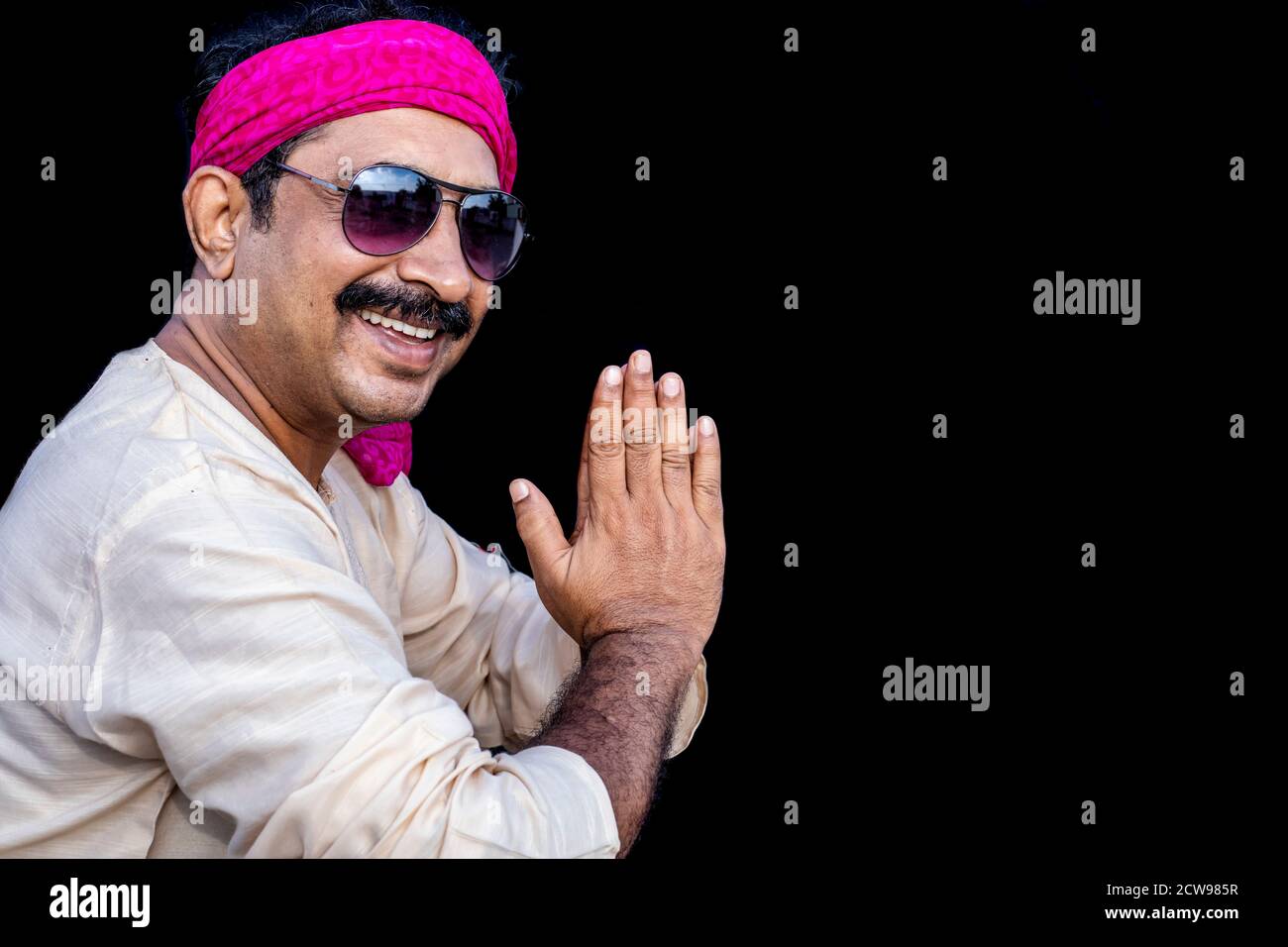 Smiling south asian man holding hand in namaste gesture Stock Photo - Alamy