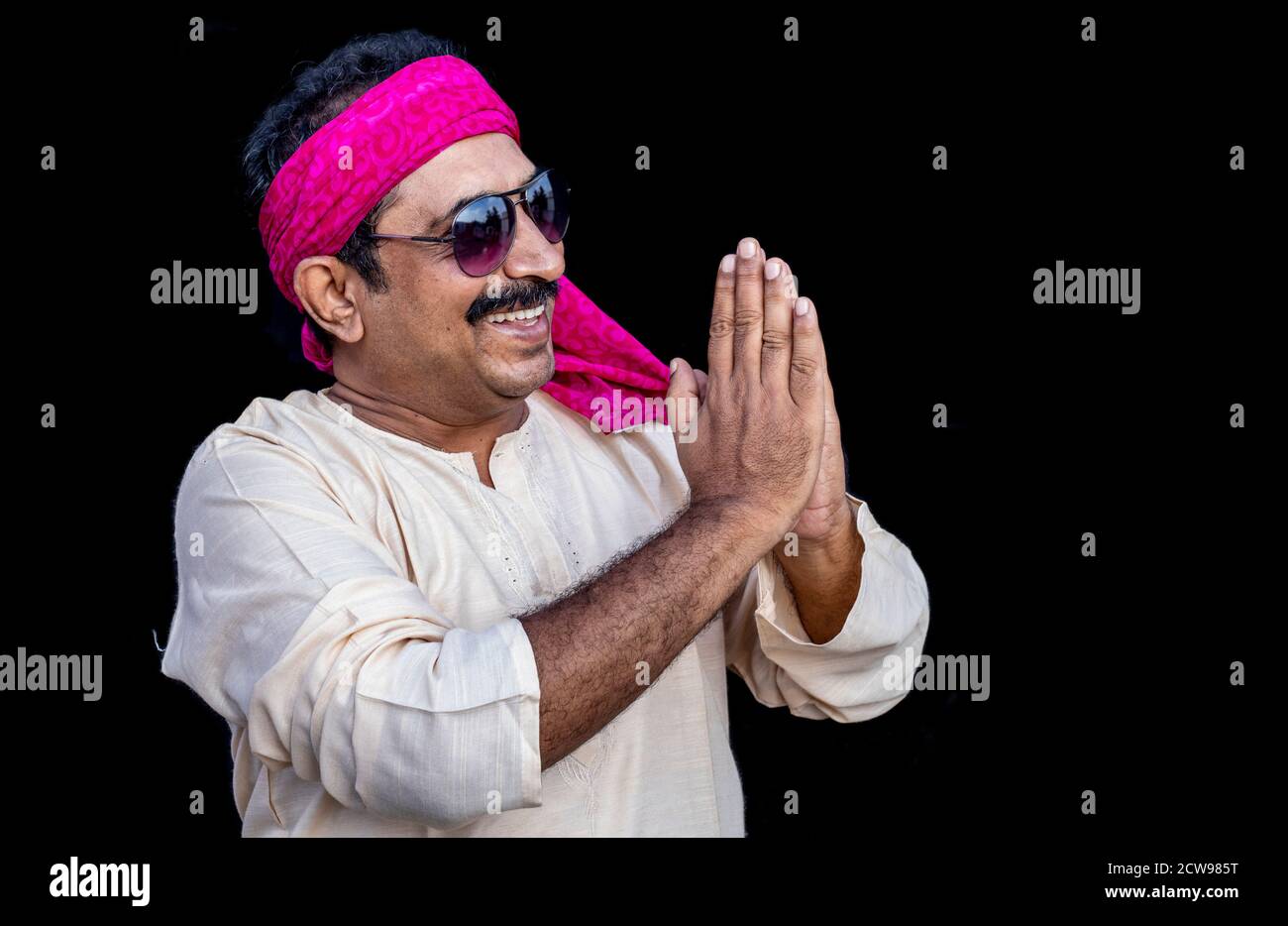 Smiling indian man holding hand in namaste gesture Stock Photo - Alamy