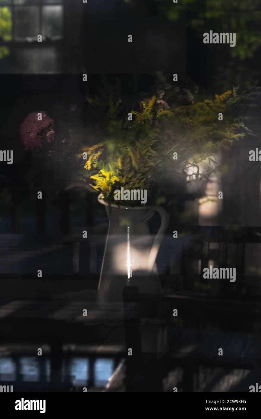 A bouquet of wildflowers inside a home, as seen through a window Stock ...