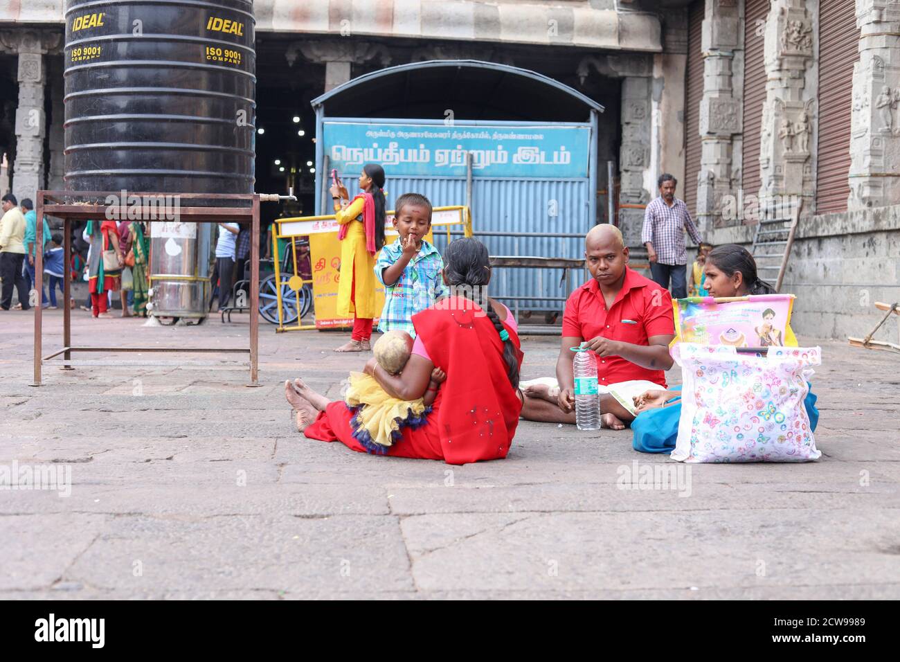 Family devotees are seated at the Arunachaleswarar Temple in the ...