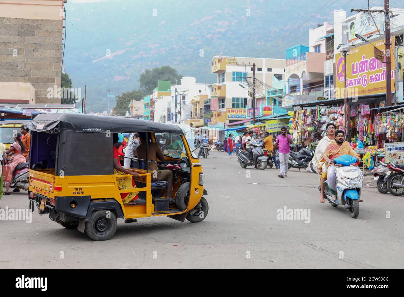 auto rickshaws driving along the street in India Stock Photo - Alamy