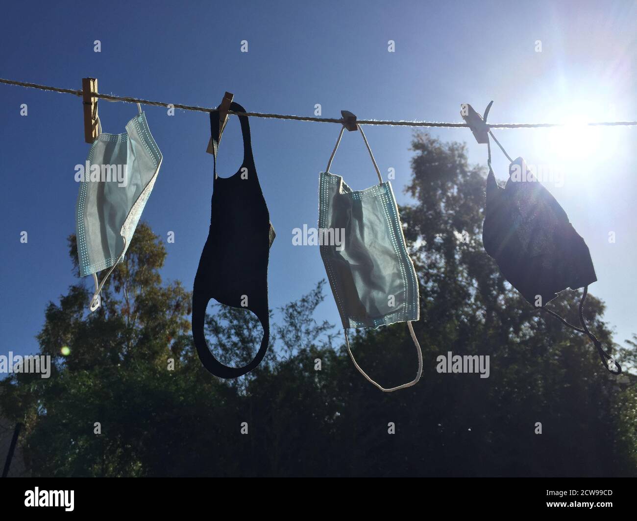 face masks on washing clothes line reusable and washed masks for ...