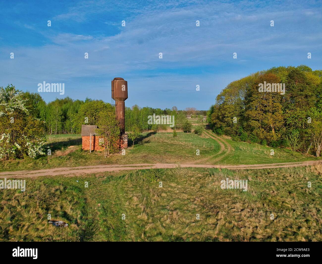 Shot of a rusty water tower in the countryside Stock Photo - Alamy