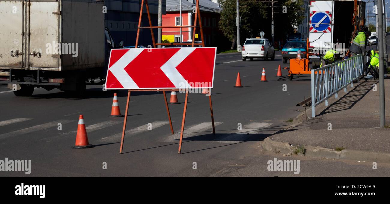 A large road sign on the road indicates the path, road works, detour of ...