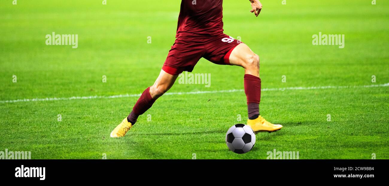 soccer game background player kicking football Stock Photo - Alamy