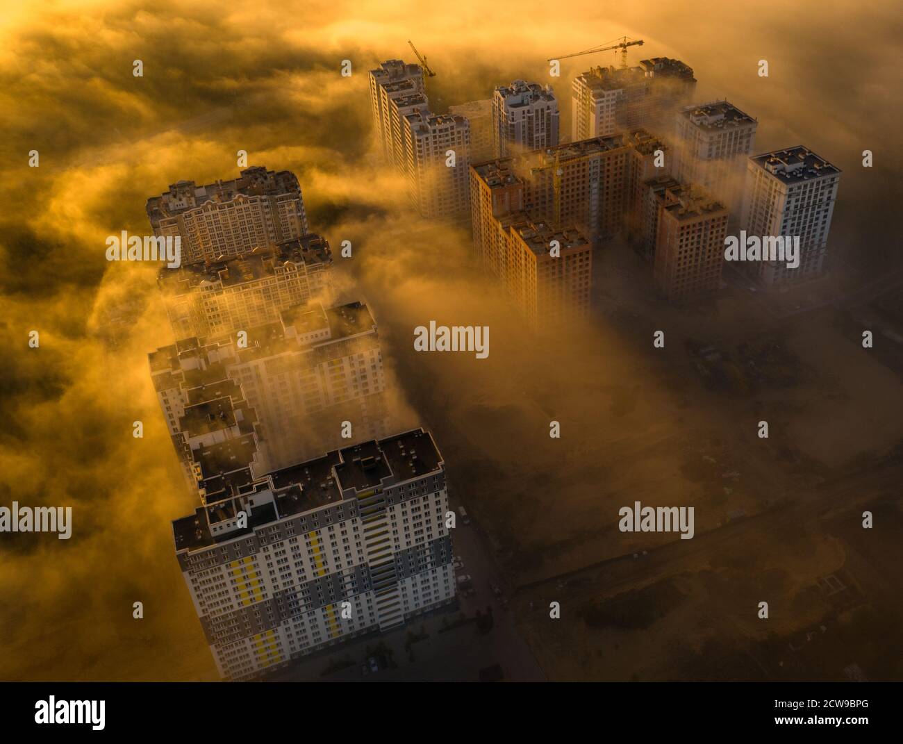 Unfinished high-rise buildings in the fog at dawn Stock Photo - Alamy