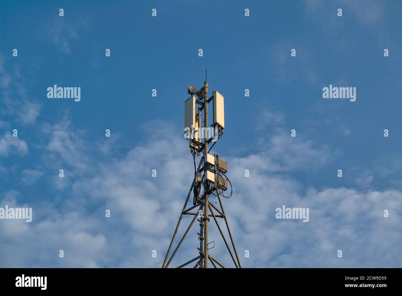 Telecommunications tower with transmitters. Base station with transmitting antennas on a ...