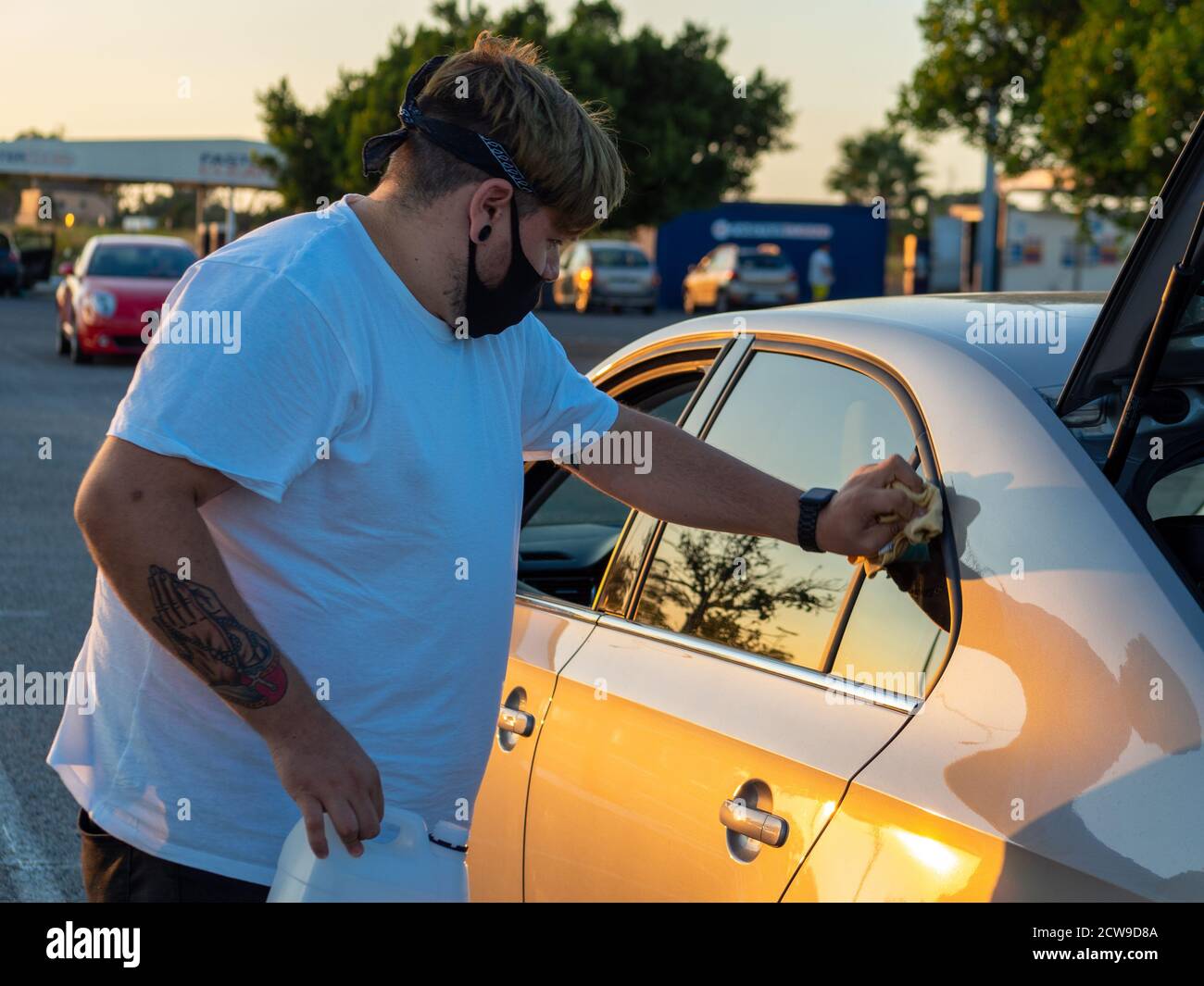Male cleaning a car with a mop Stock Photo - Alamy