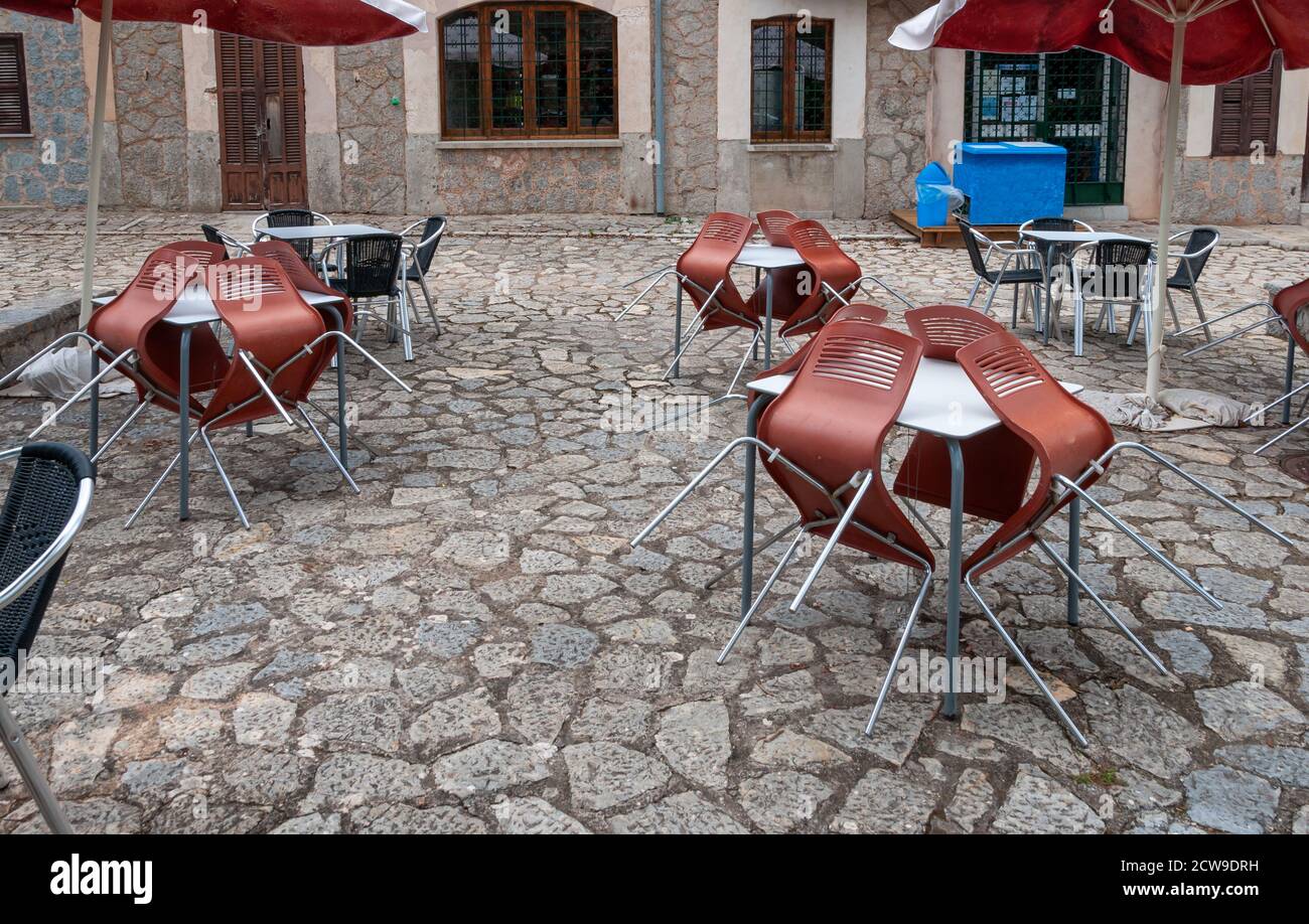 Outdoor cafe with chairs leaning on tables before opening Stock Photo ...