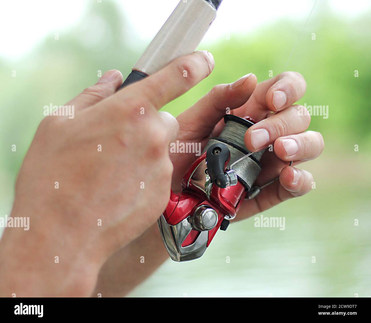 Fishing with red fisher reel Stock Photo - Alamy