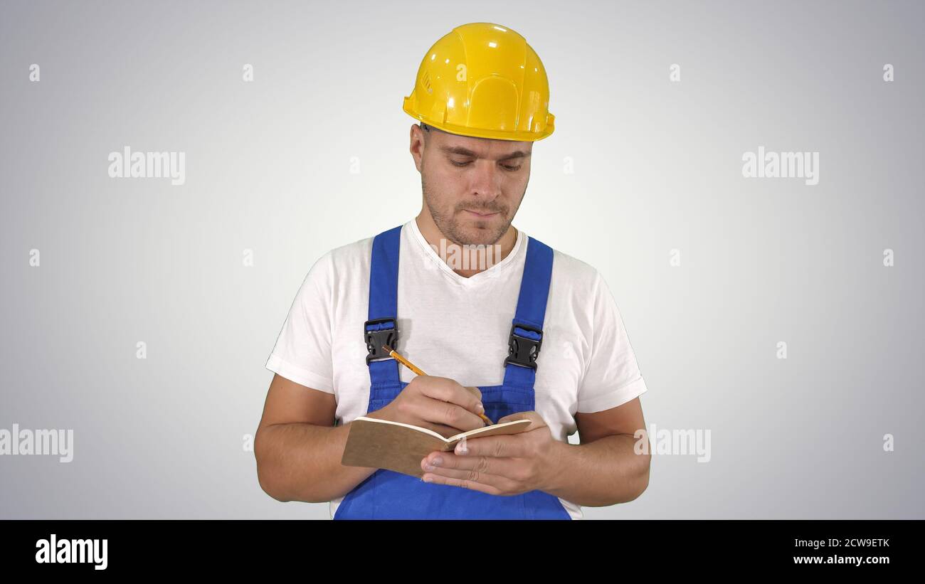 Construction worker writing to do list or checklist on gradient Stock ...