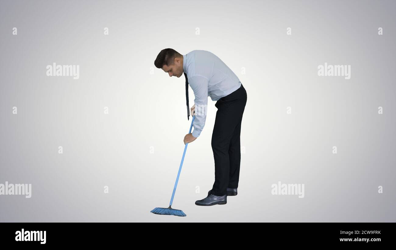 Man in official clother sweeping the floor on gradient background Stock ...
