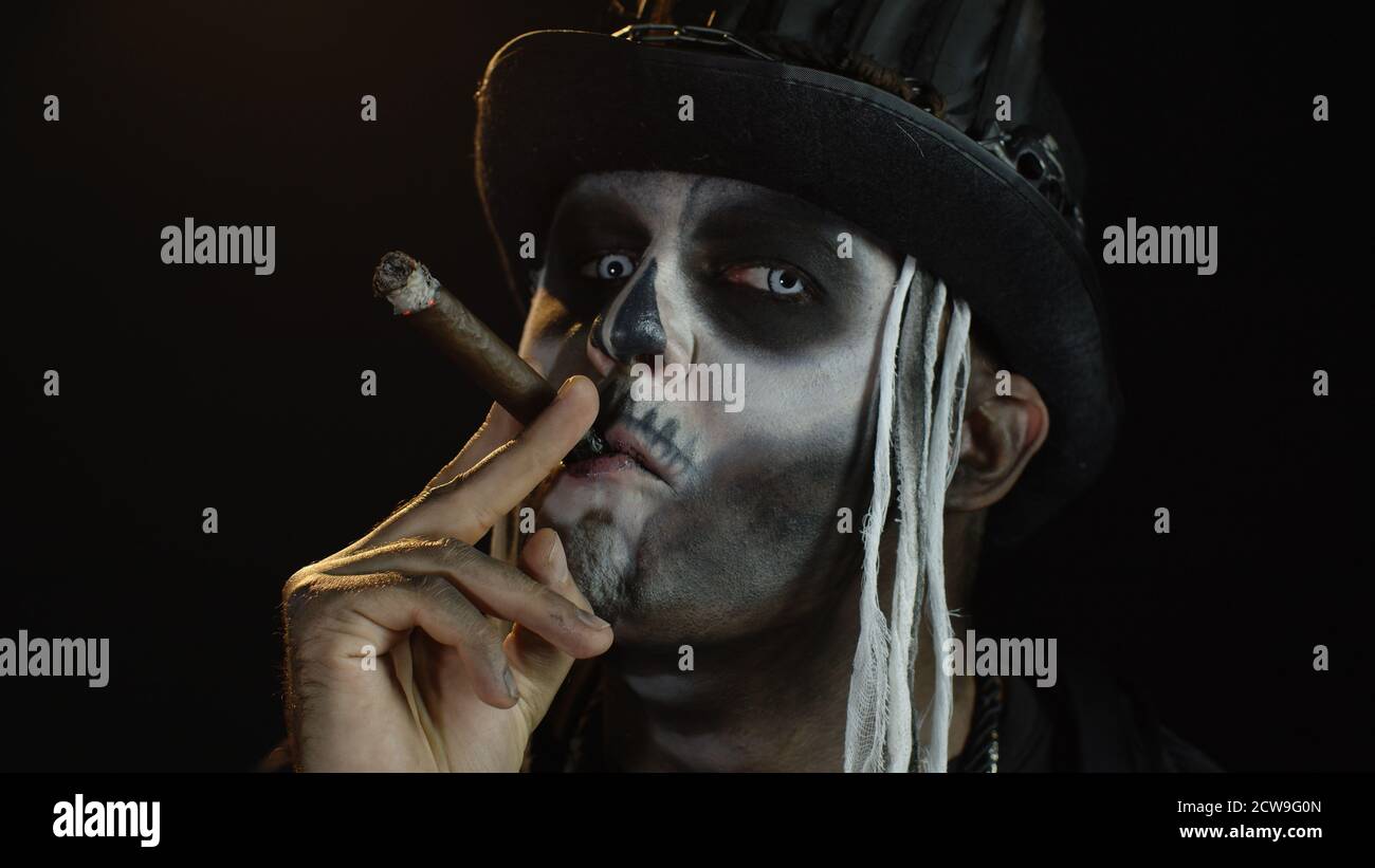 Close-up shot of sinister man with Halloween holiday skeleton makeup in ...