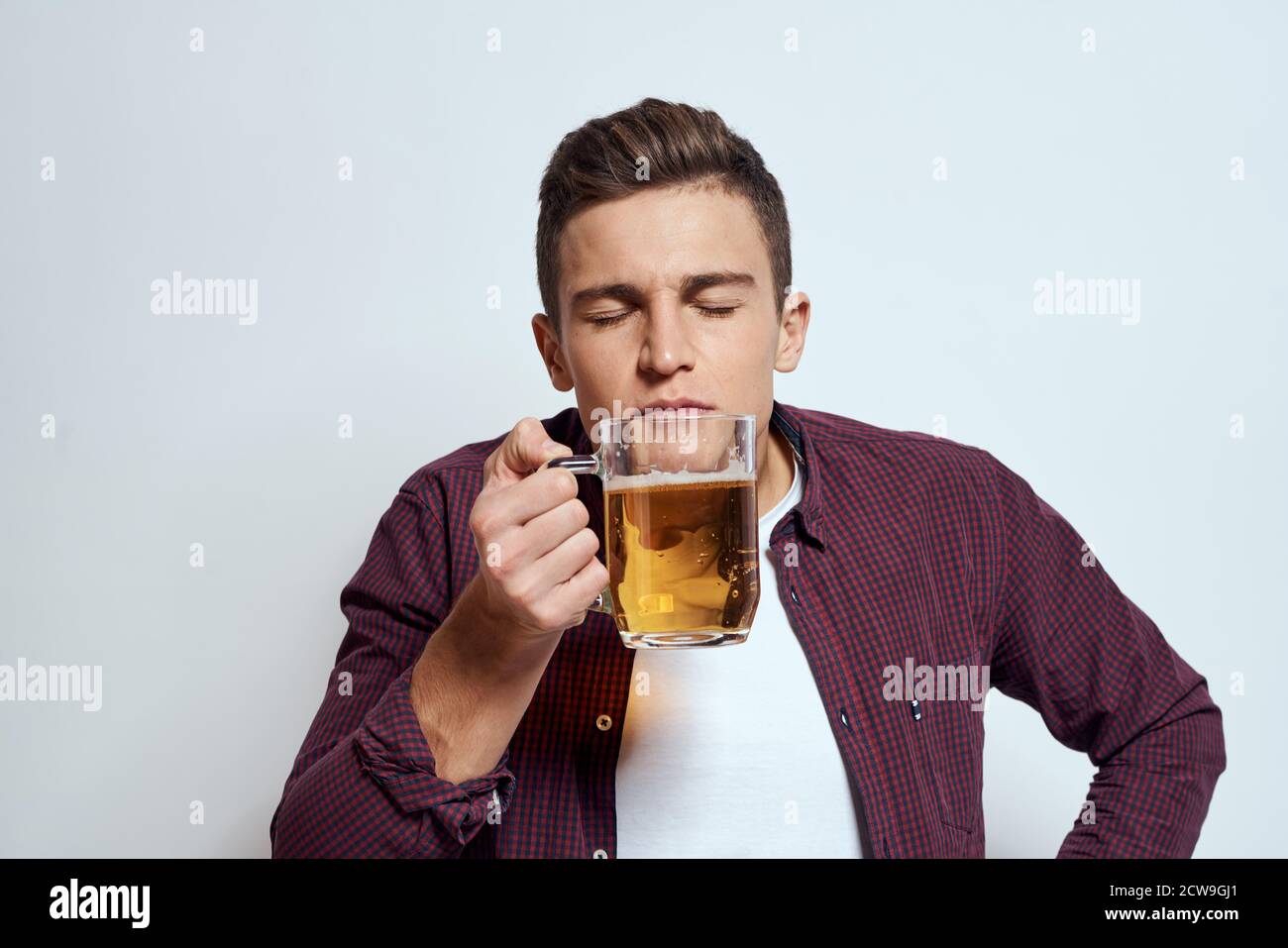 Drunk man with a mug of beer vacation alcohol lifestyle in a red shirt ...