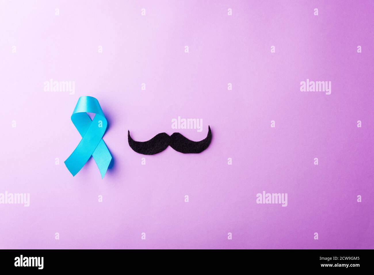 Black mustache paper and light blue ribbon, studio shot isolated on ...