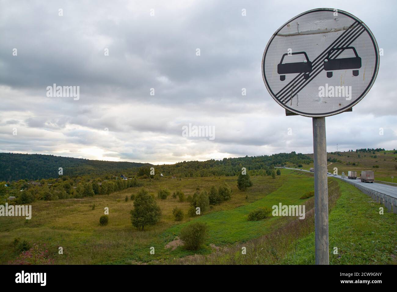 road sign on the background of mountains and cloudy sky Stock Photo - Alamy
