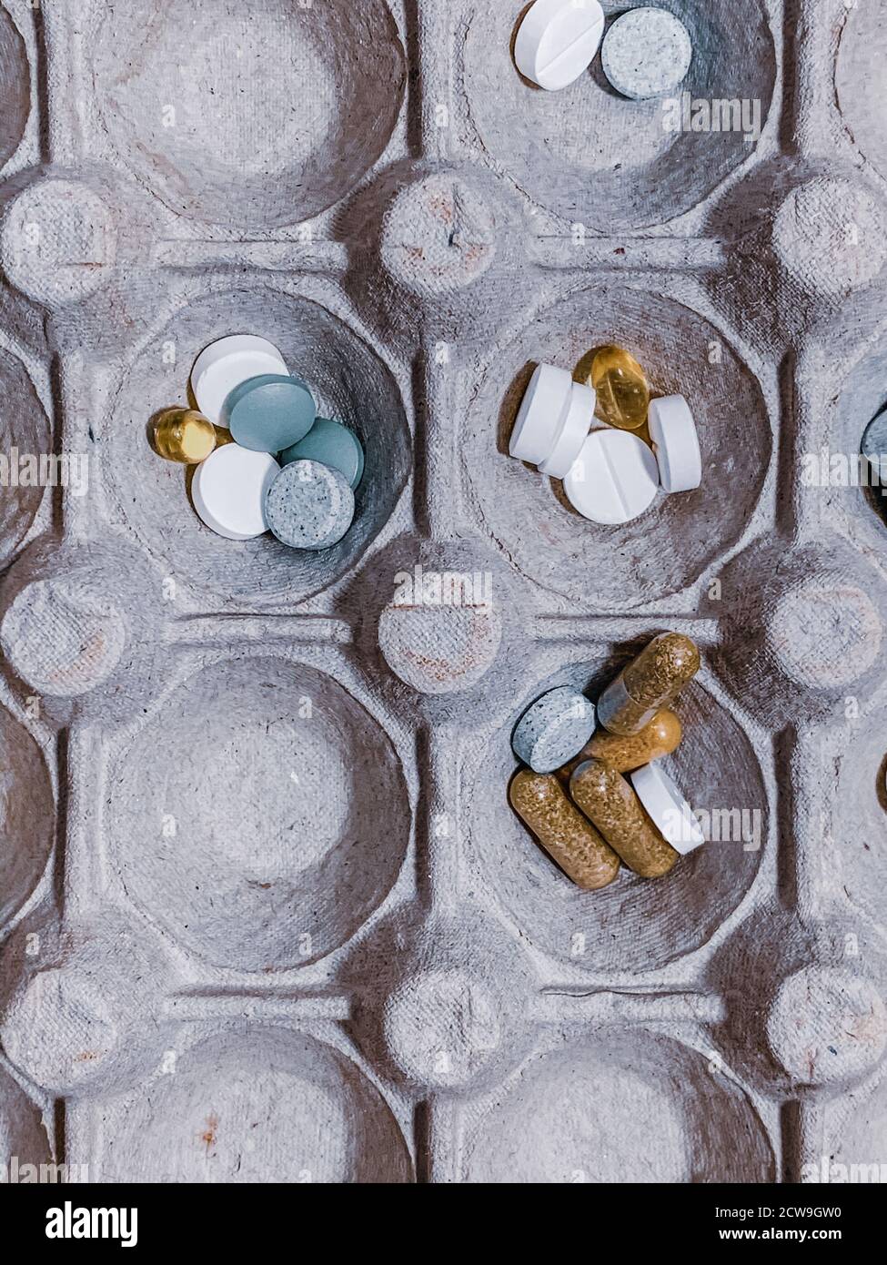 Vertical top view of pills and capsules in a container Stock Photo - Alamy