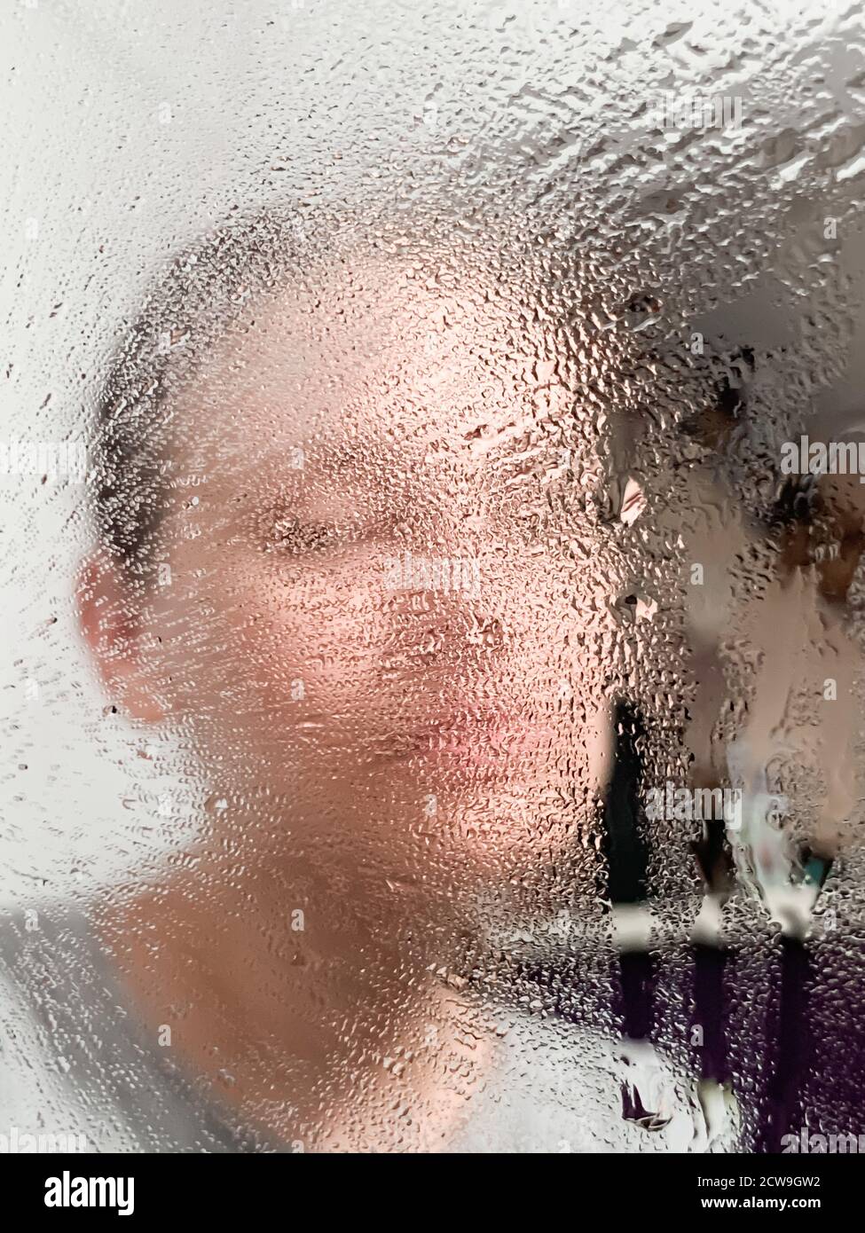 Vertical shot of a female face in a wet mirror Stock Photo - Alamy