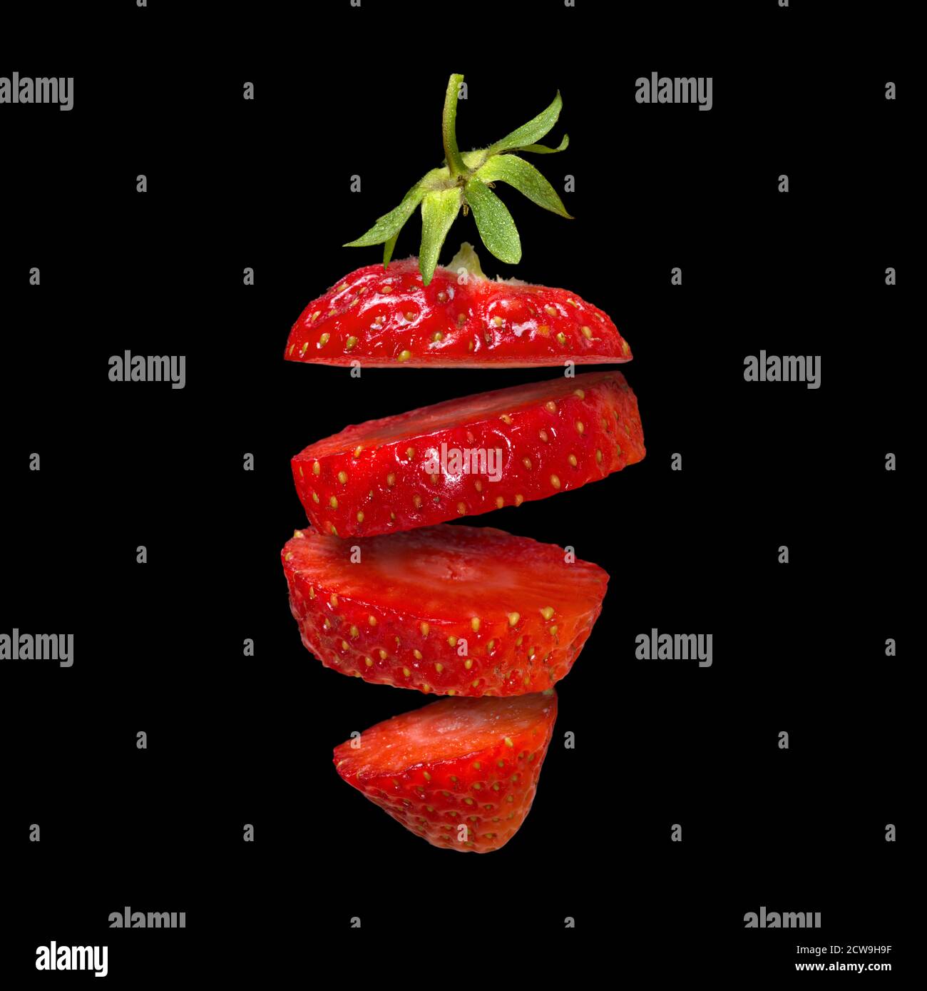 Strawberry slices isolated on black background. Surreal design. Pieces ...