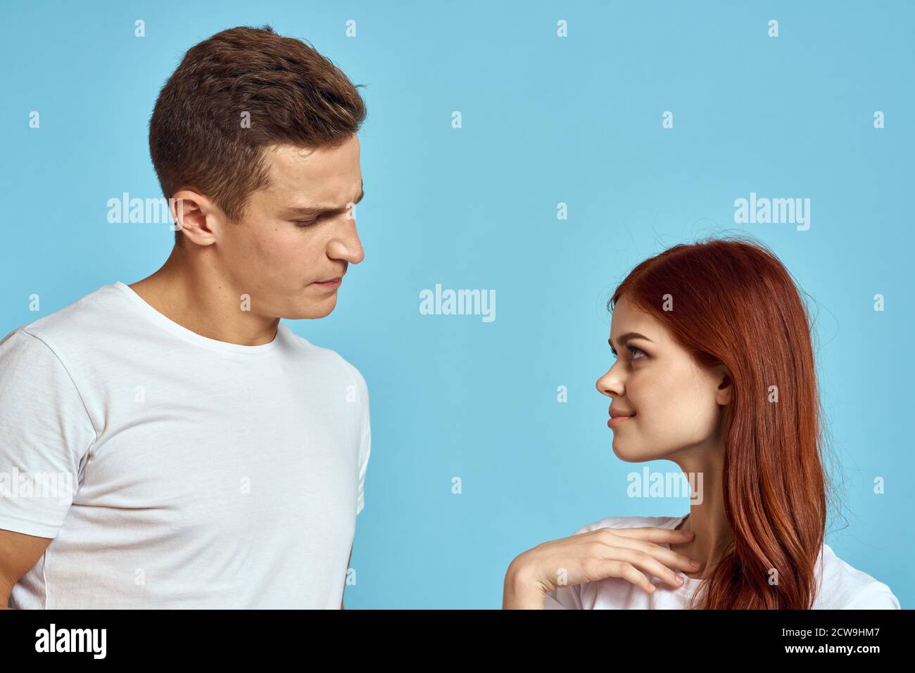 Young woman and man stinks relationship on blue background cropped view ...