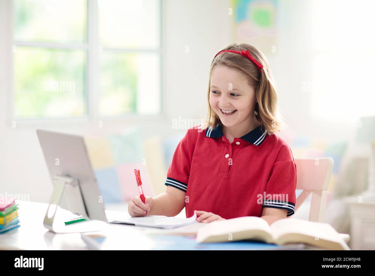 Online remote learning. School kids with computer having video ...