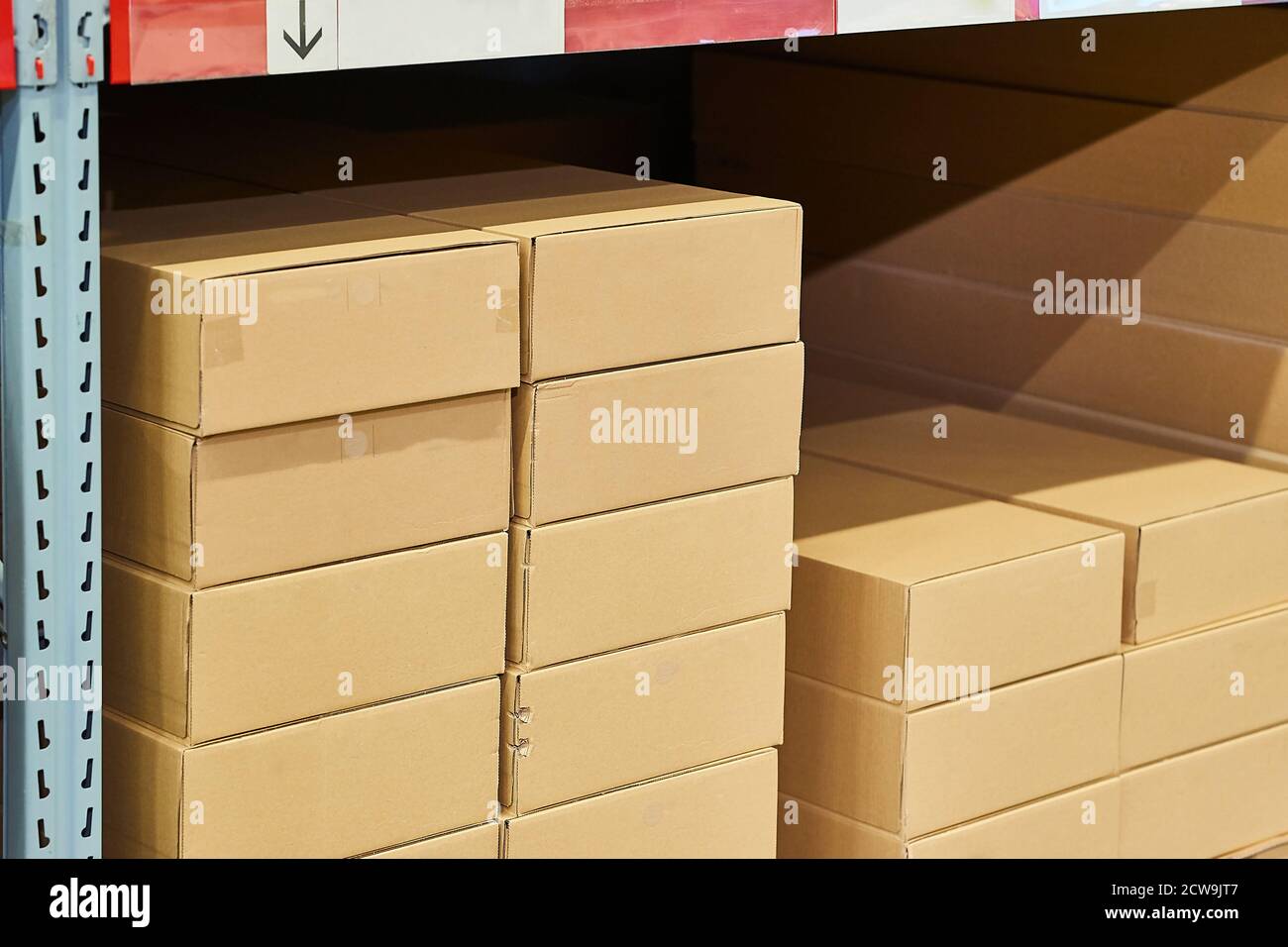 Warehouse stocked with boxes in stacks Stock Photo - Alamy