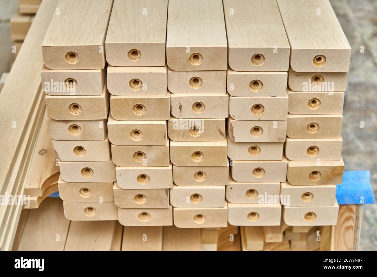 Joinery. Wooden table legs. Stacked wooden table legs in workshop ...