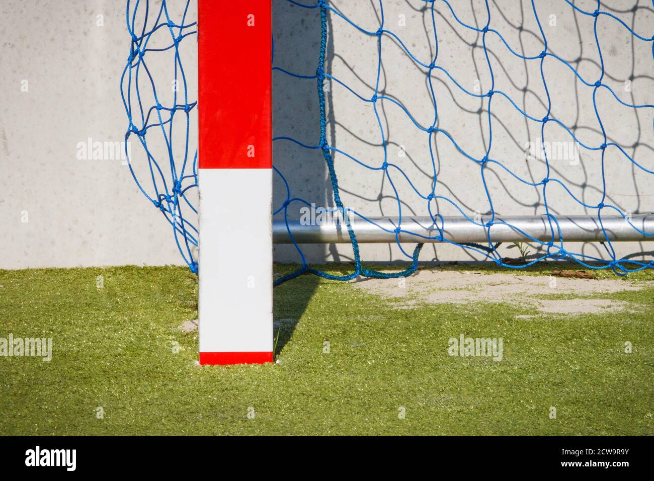 Goal with red and white goalpost for football or handball on playground ...