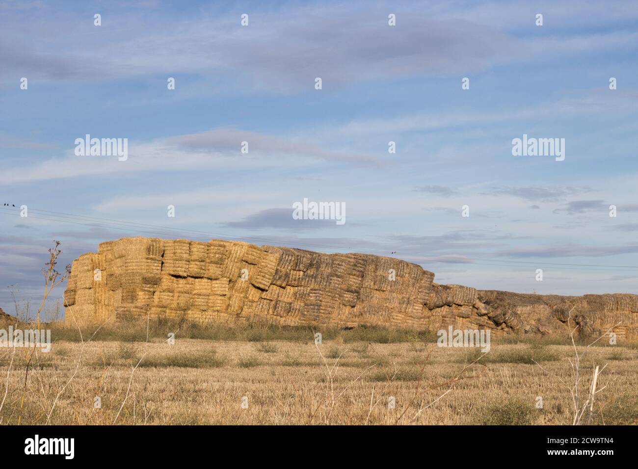 View of a rocky cliff with thin clouds background Stock Photo - Alamy