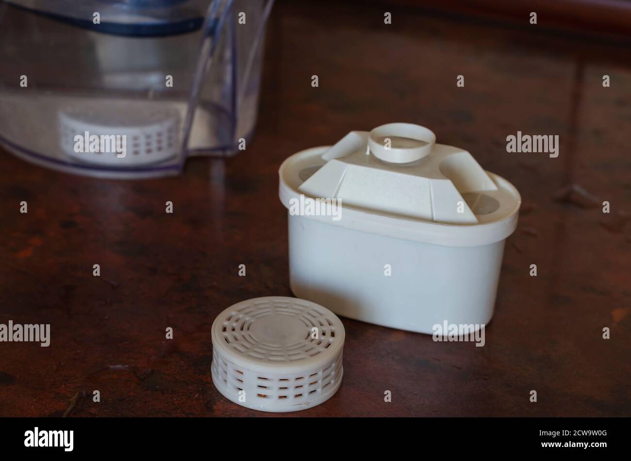 Tap water purification cartridge and silicon filter on the table ...