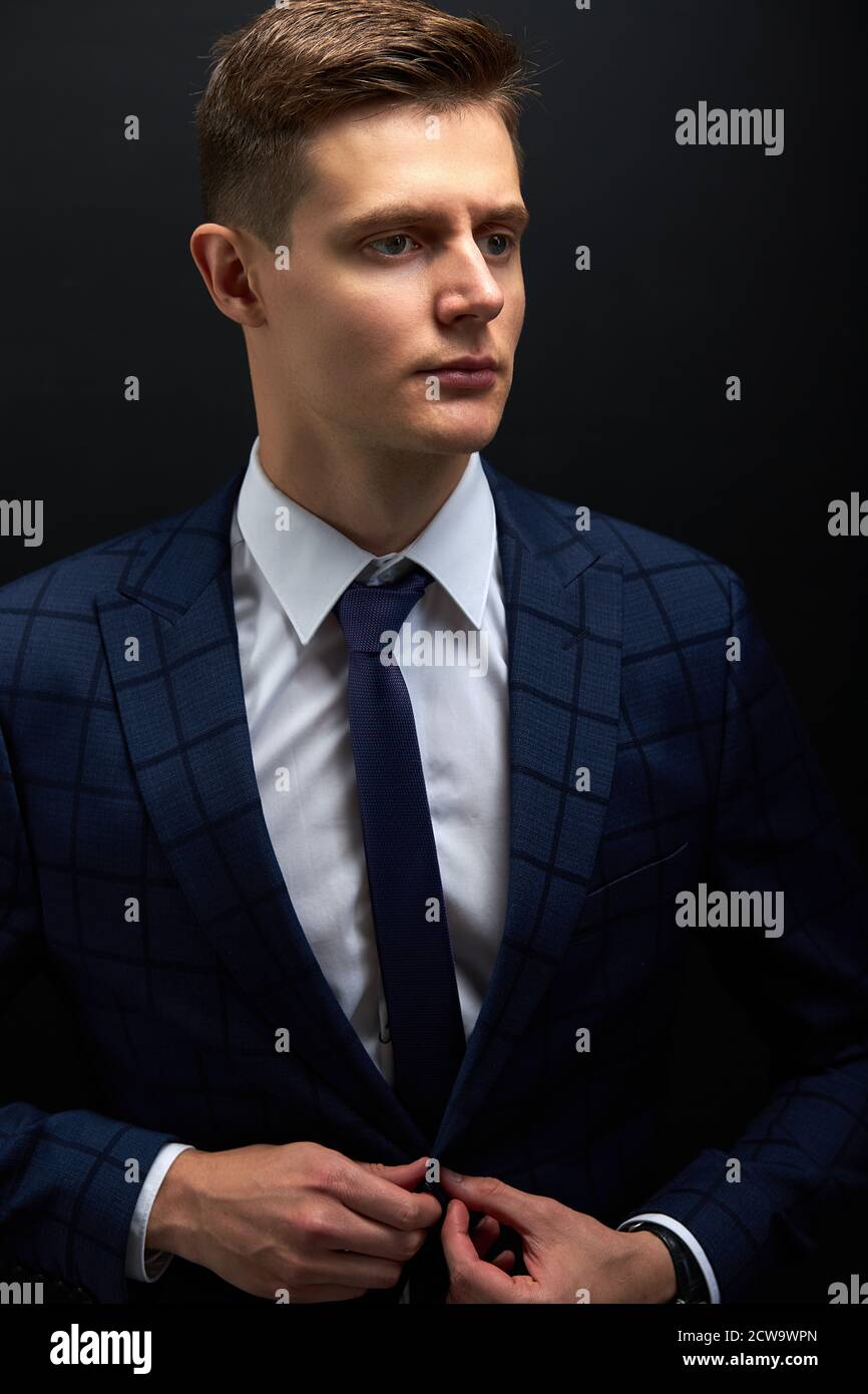 thoughtful young business man in classic black suit shirt posing ...