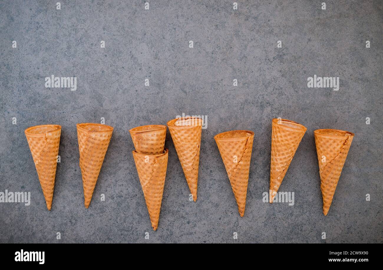 Flat lay ice cream cones collection on dark stone background . Blank ...