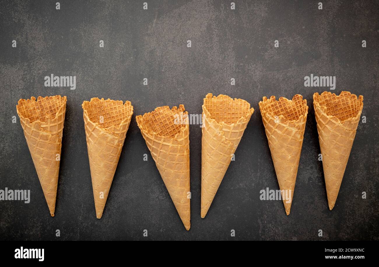 Flat lay ice cream cones collection on dark stone background . Blank ...