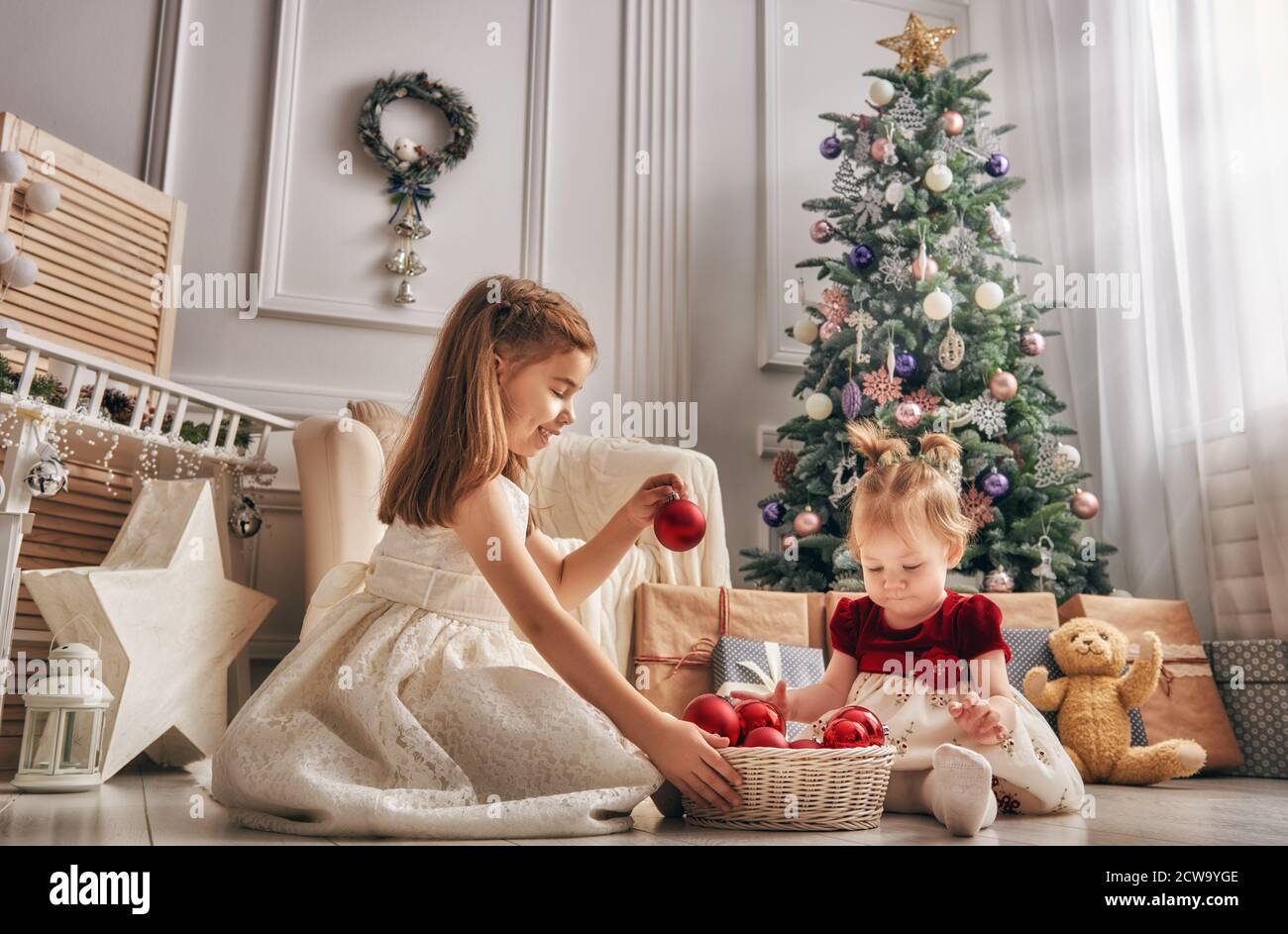 Merry Christmas and Happy Holiday! Two cute children sisters girls ...