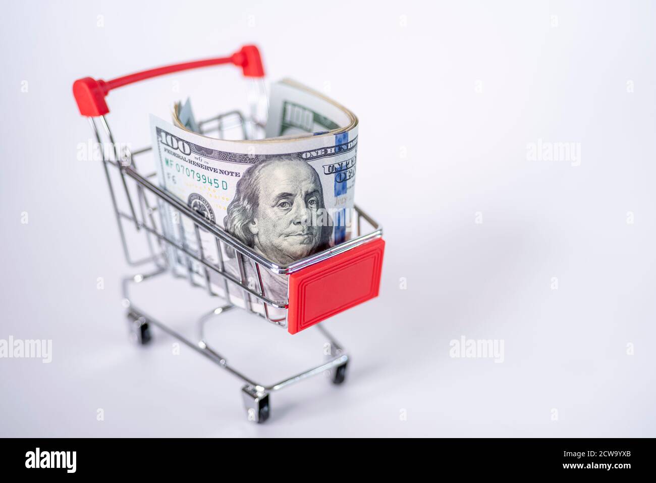 The cart from the supermarket is filled with money. Dollars in a ...