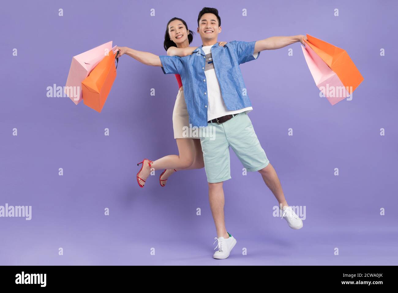The vitality of the young couples carry shopping bags Stock Photo - Alamy